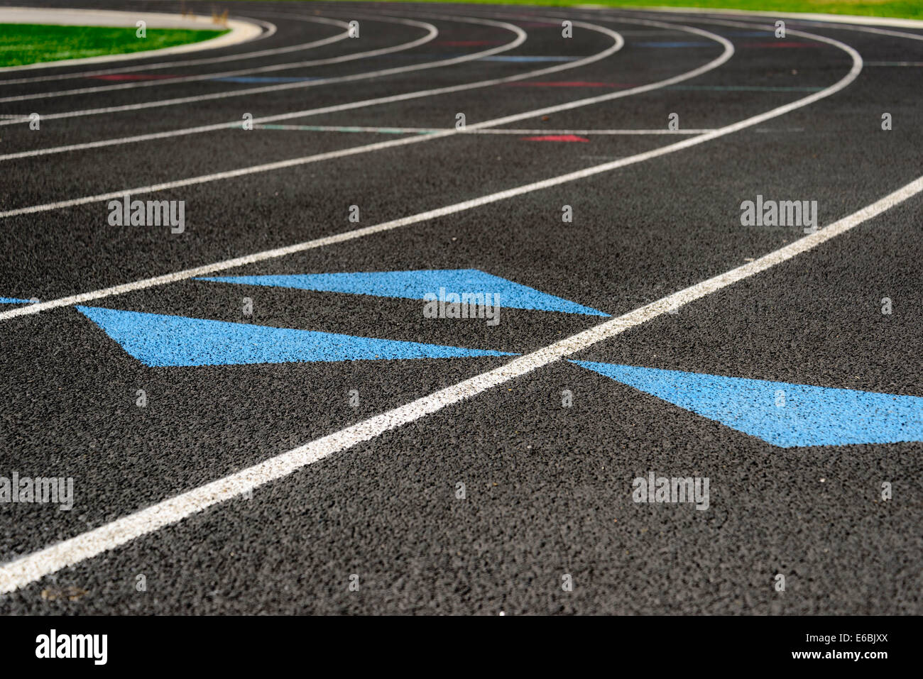 outdoor black running track with painted lane lines Stock Photo - Alamy