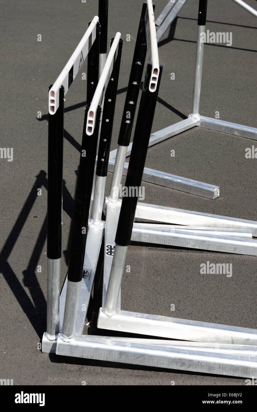 hurdles on an outdoor black running track with painted lane lines Stock ...