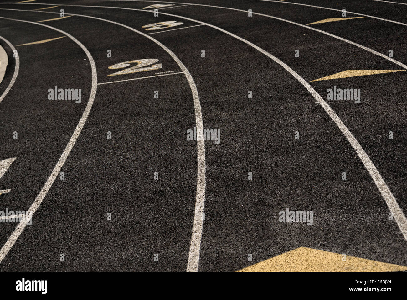 outdoor black running track with painted lane lines Stock Photo - Alamy