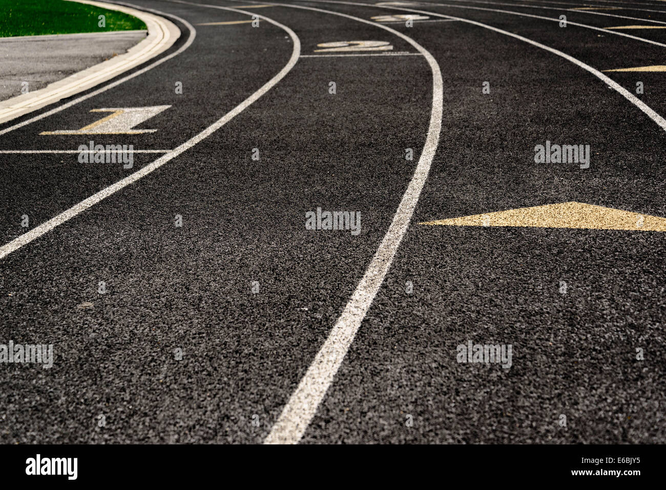 outdoor black running track with painted lane lines Stock Photo - Alamy