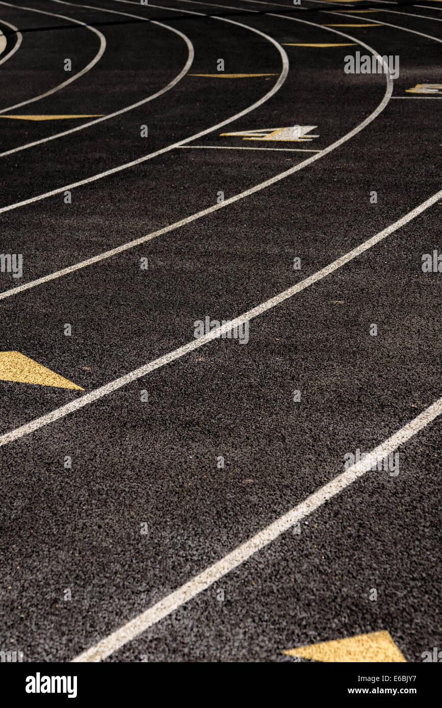 outdoor black running track with painted lane lines Stock Photo - Alamy