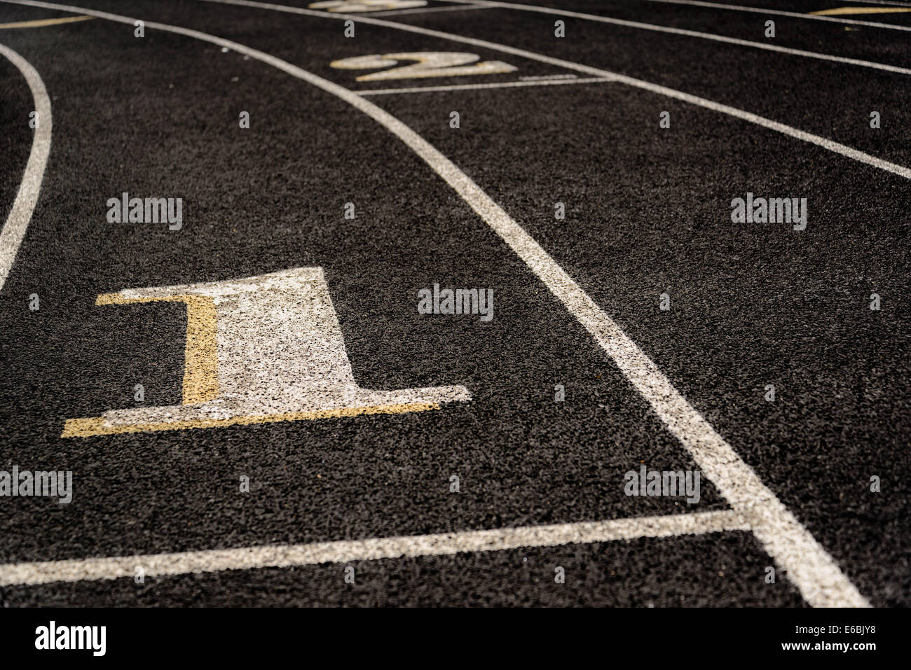 outdoor black running track with painted lane lines Stock Photo - Alamy