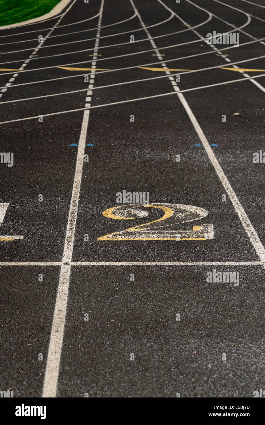 outdoor black running track with painted lane lines Stock Photo - Alamy