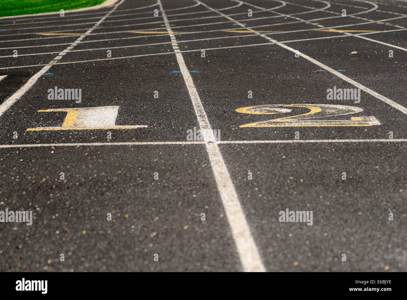 outdoor black running track with painted lane lines Stock Photo - Alamy