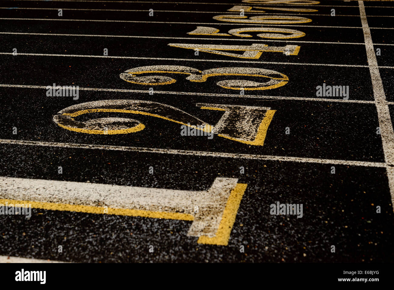 outdoor black running track with painted lane lines Stock Photo - Alamy