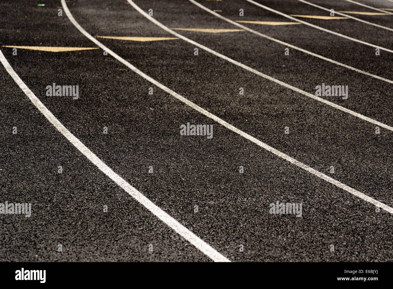 outdoor black running track with painted lane lines Stock Photo - Alamy
