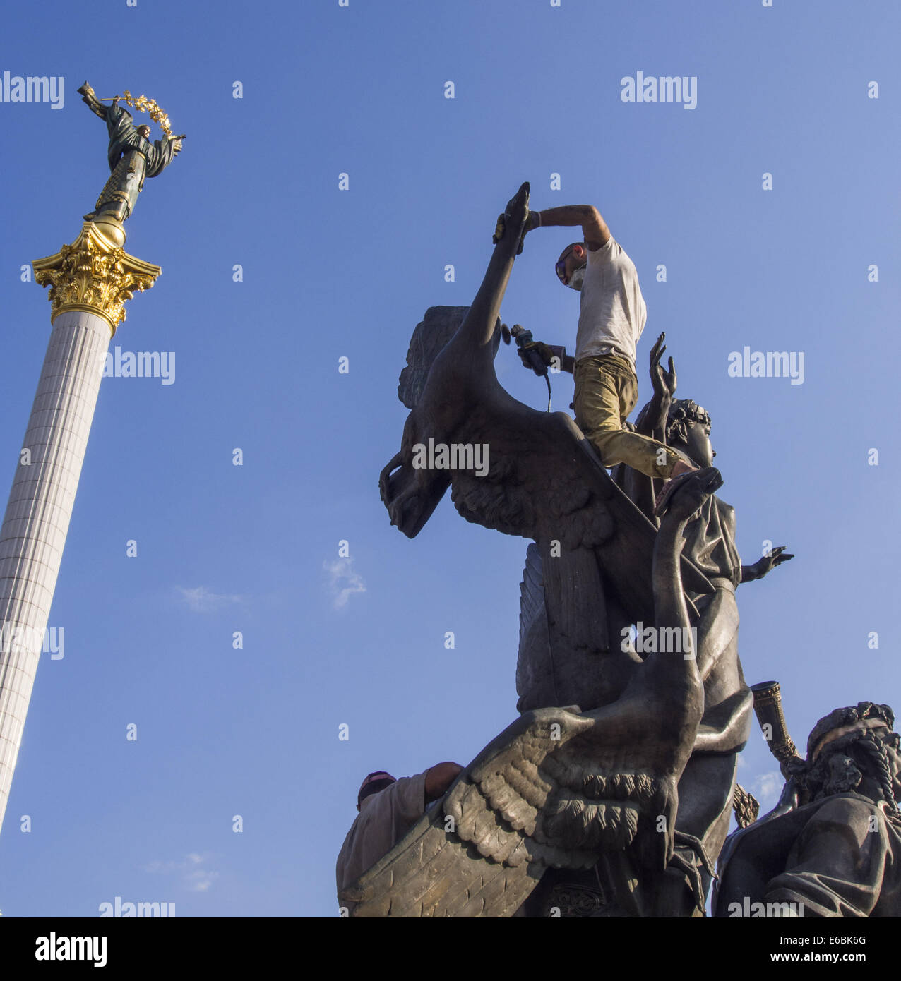 Workers polish a statue in Maidan as they prepare the Kiev square in ...