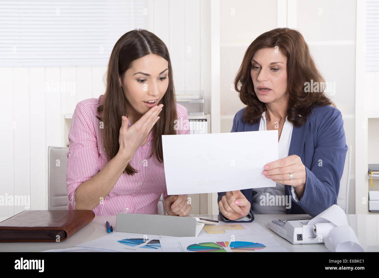 Successful teamwork under business woman - happy about increasing ...