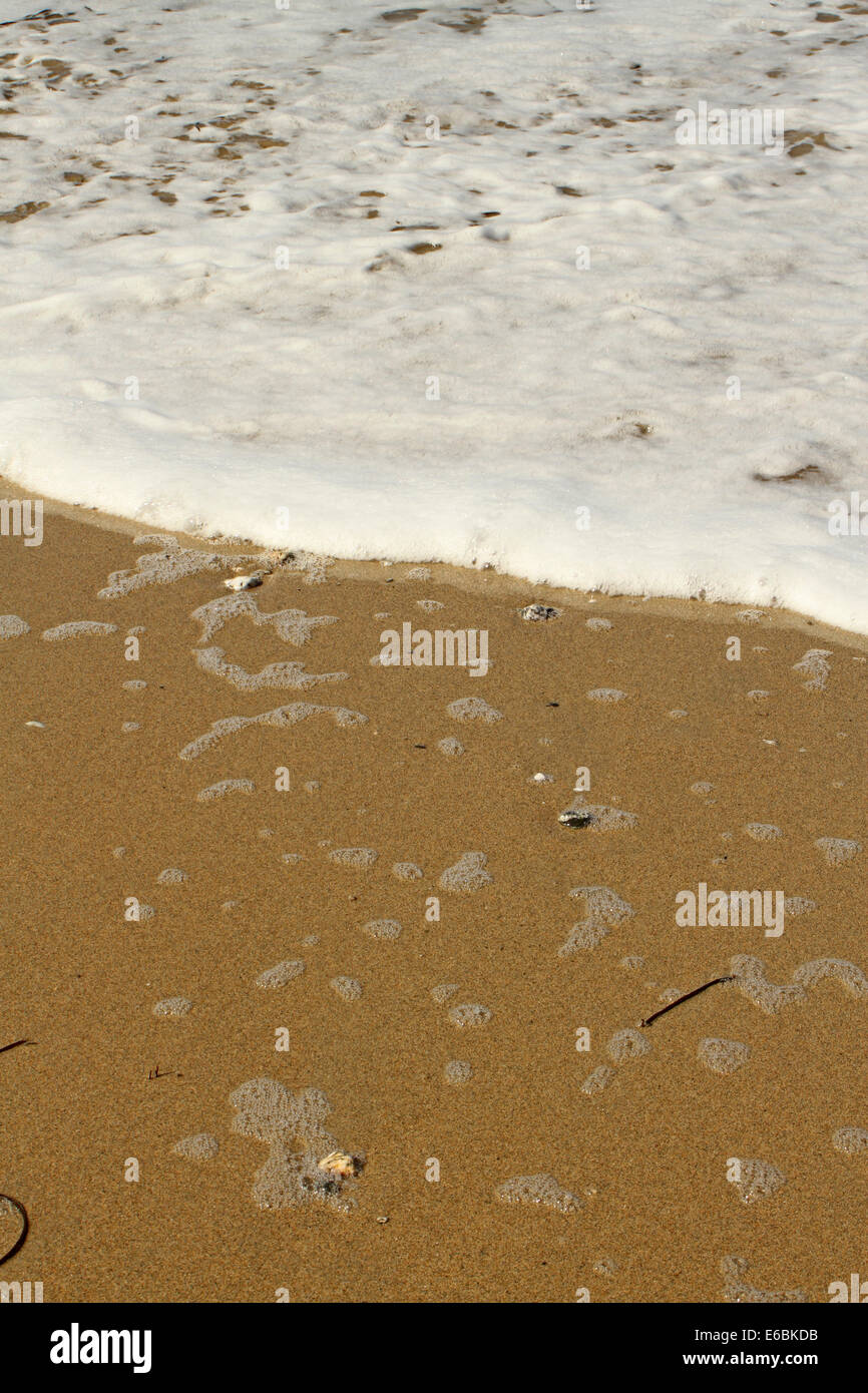 White foam small wave on the sandy shoreline Stock Photo - Alamy