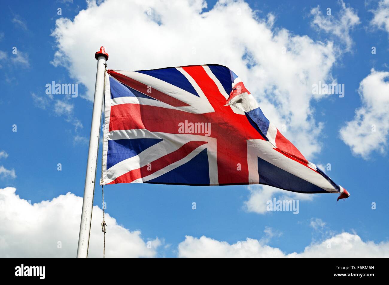 British Union Jack flag against a blue sky, UK Stock Photo - Alamy