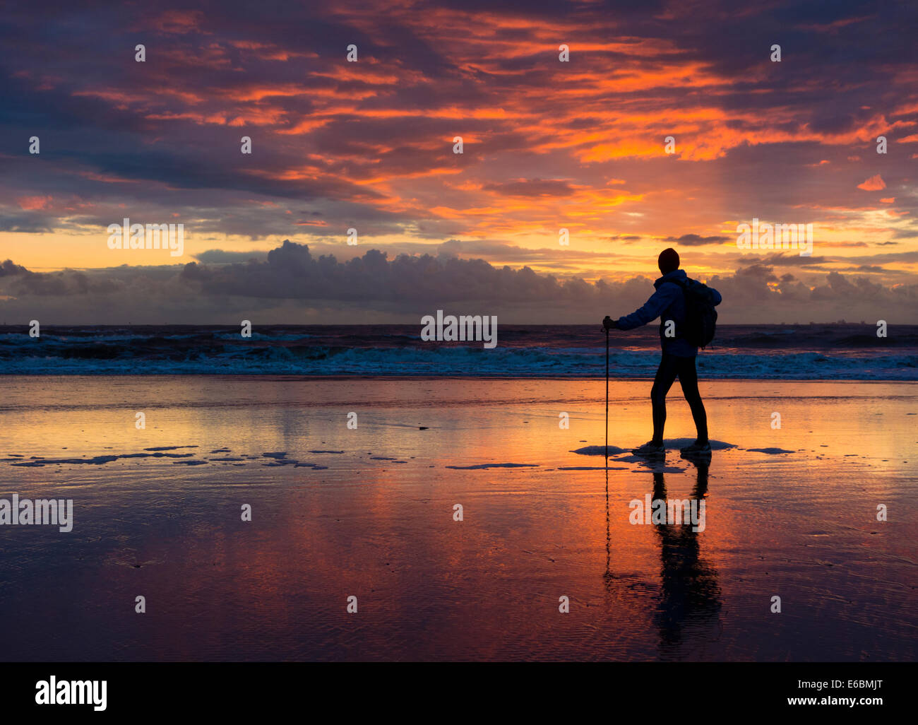 A walker on Seaton Carew beach at sunrise, setting out on the 55km ...