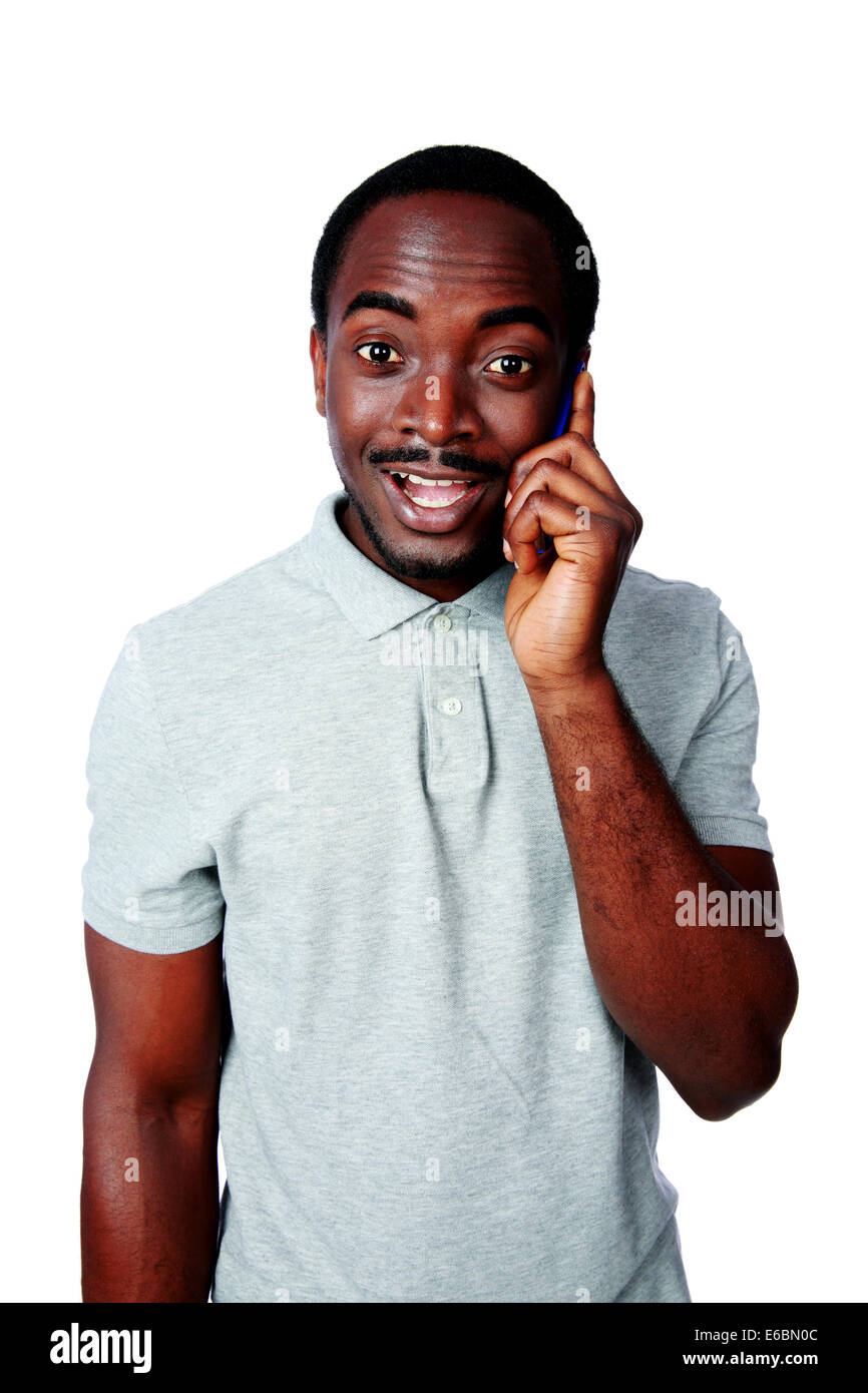 Funny african man talking on the phone isolated on a white background ...