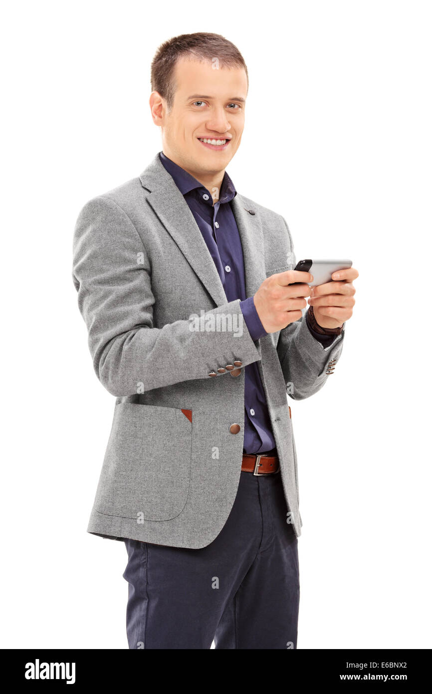Young man typing a message on his cell phone Stock Photo - Alamy