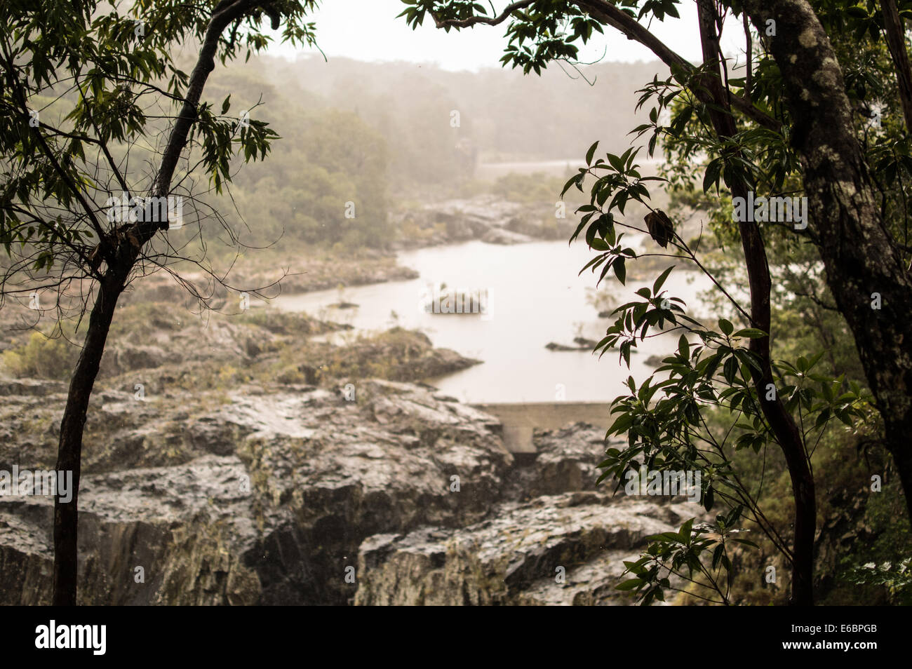 Edge of waterfall peering through the trees of the Australian ...