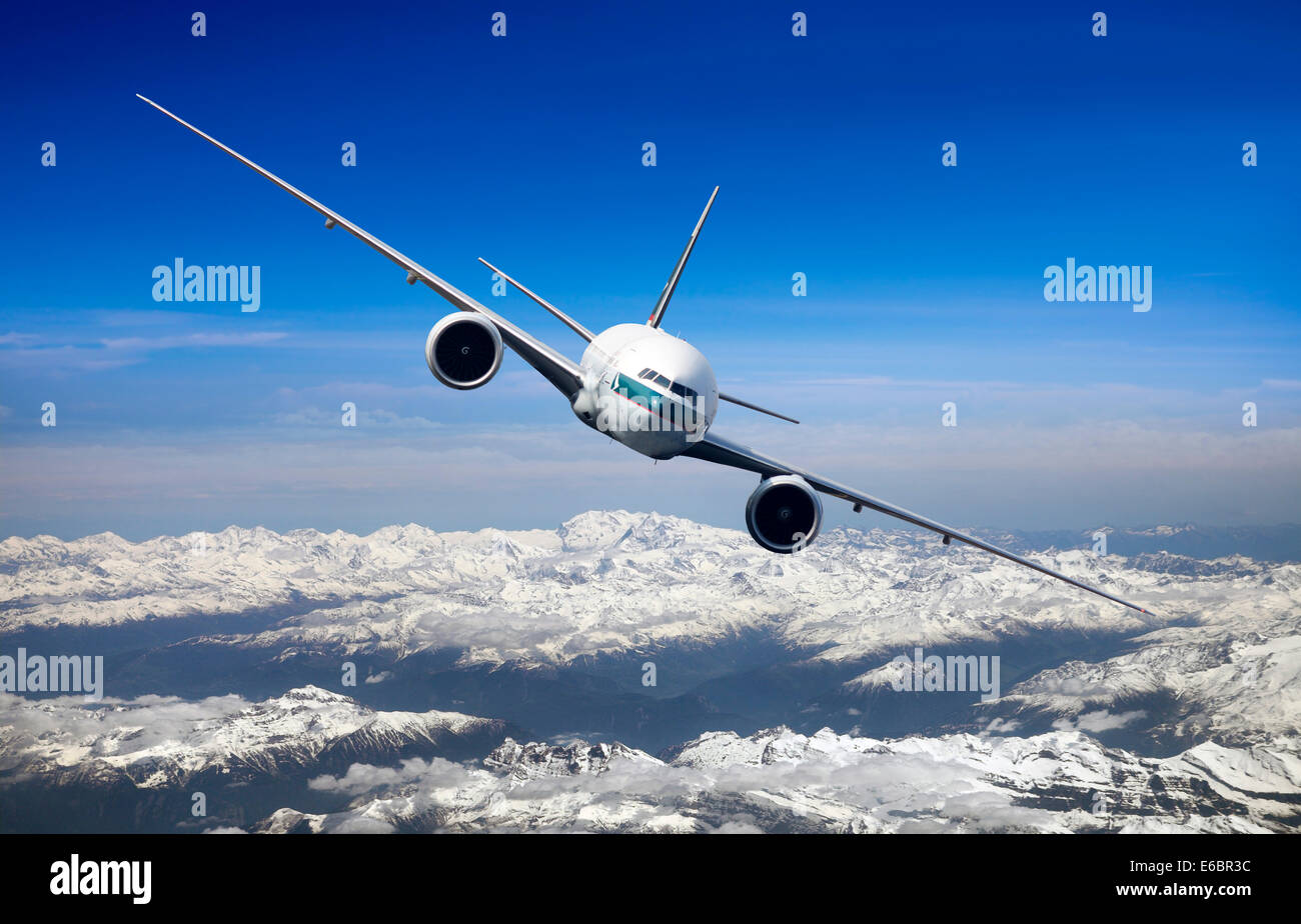 Cathay Pacific Boeing 777-367 ER in flight over mountains Stock Photo ...