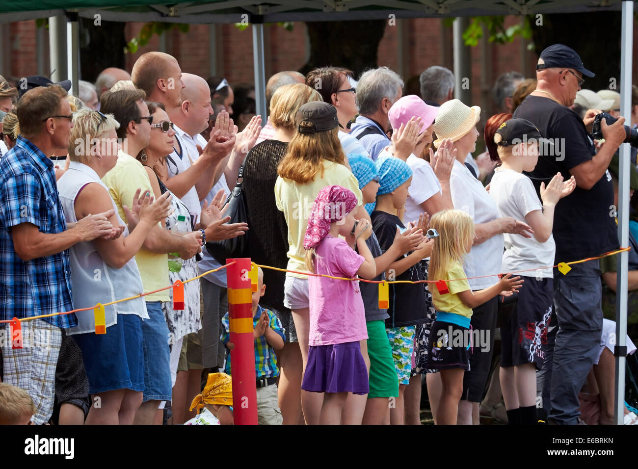 crowd of spectators behind security line Stock Photo - Alamy