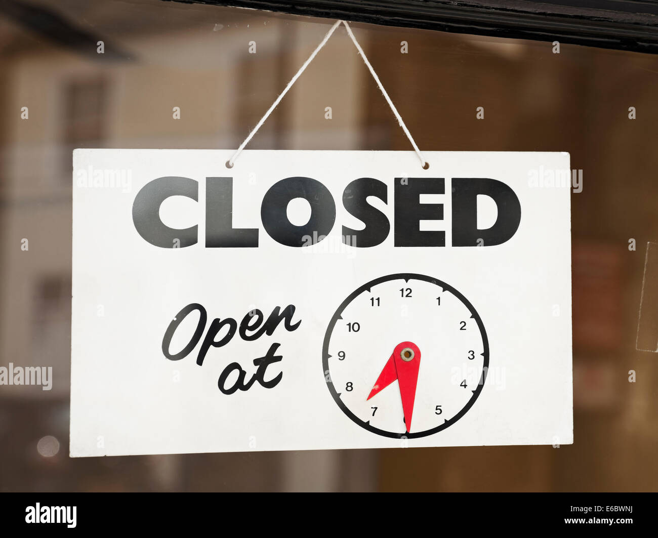 Close up of closed sign on shop store door window shopfront England UK ...