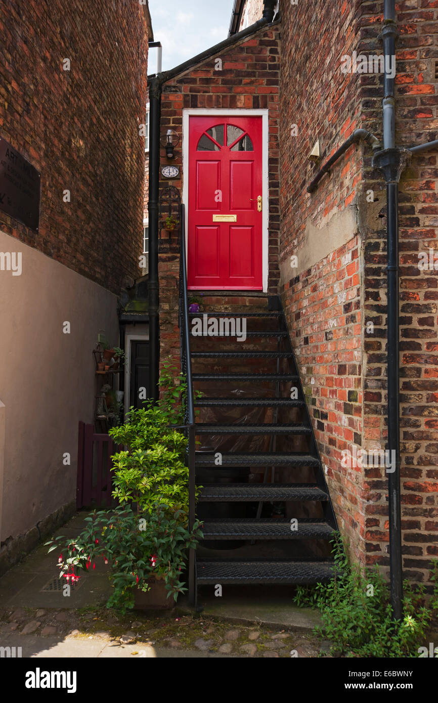Steps stairs leading up to Red painted house flat door England UK ...