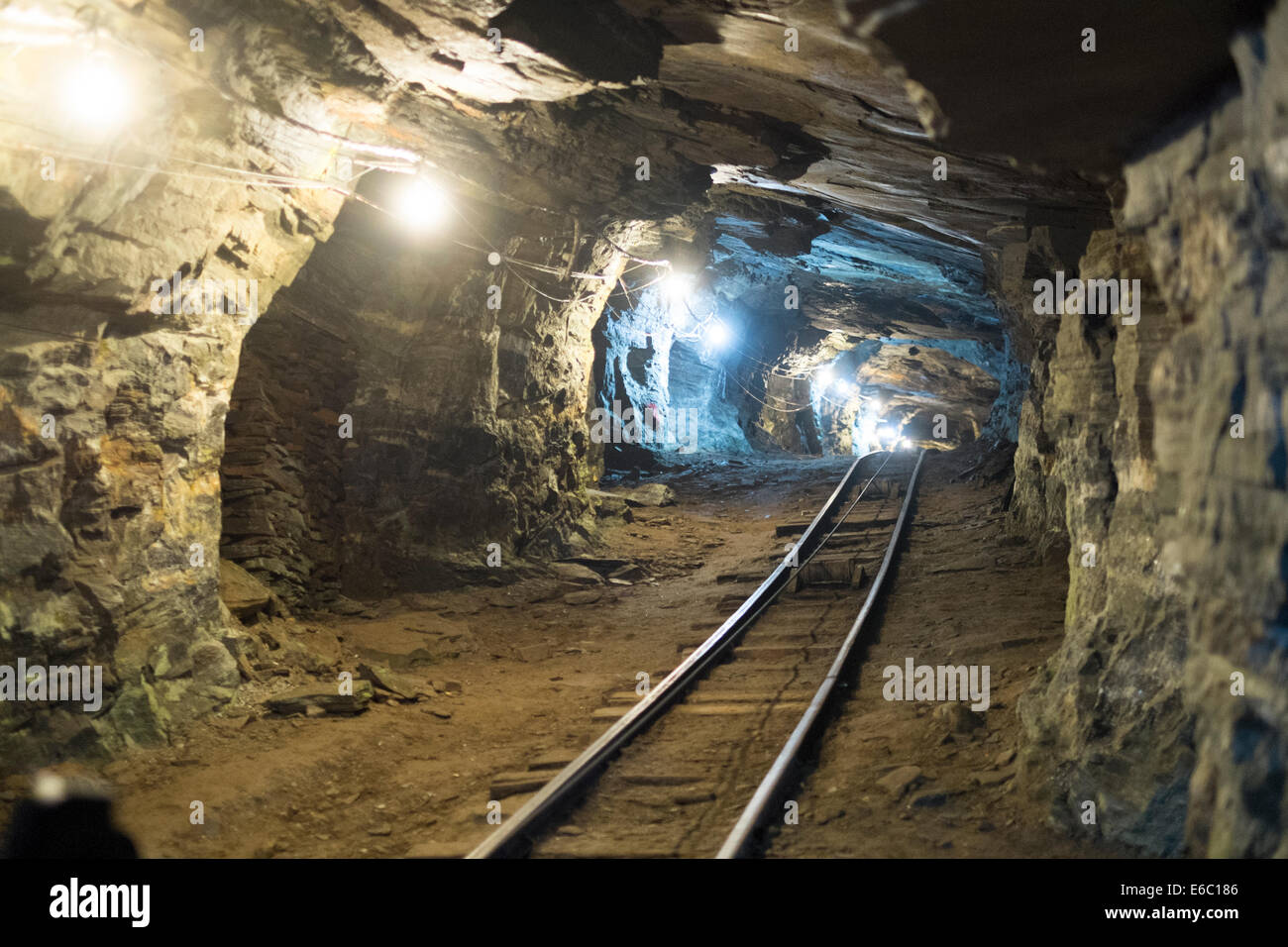 Perspective shot of gold mine tunnel with rail track for chart Stock ...