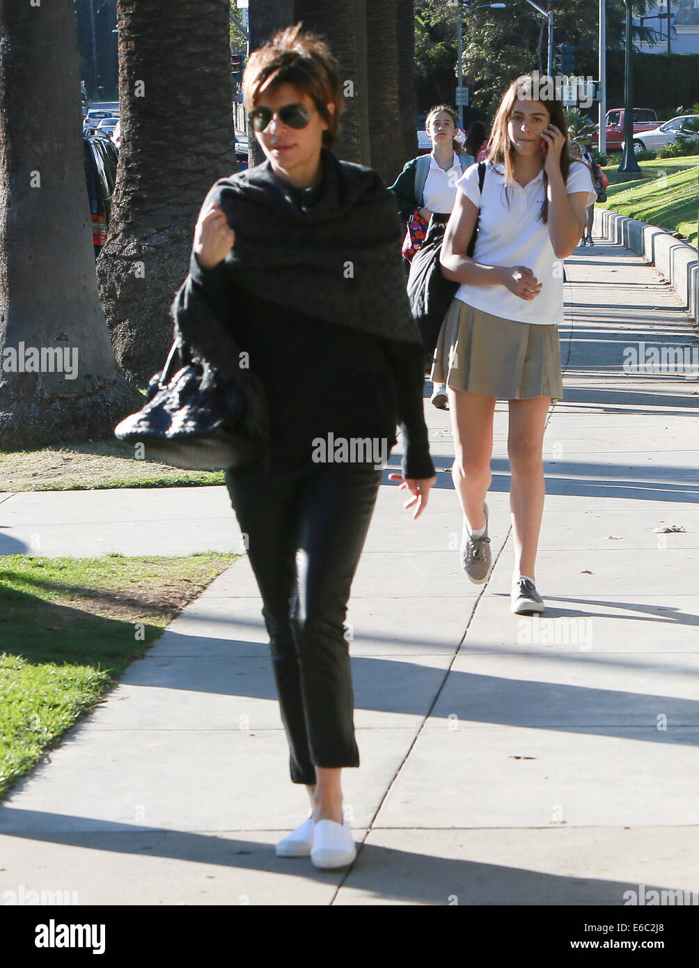 Lisa Rinna dressed all in black with skinny leather trousers and white ...