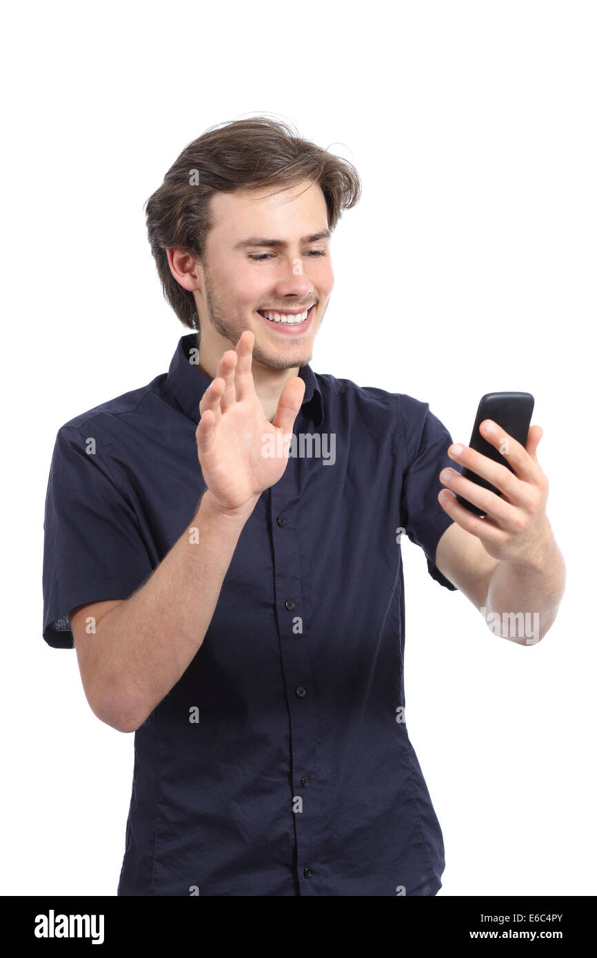 Happy man waving to a smart phone camera isolated on a white background ...