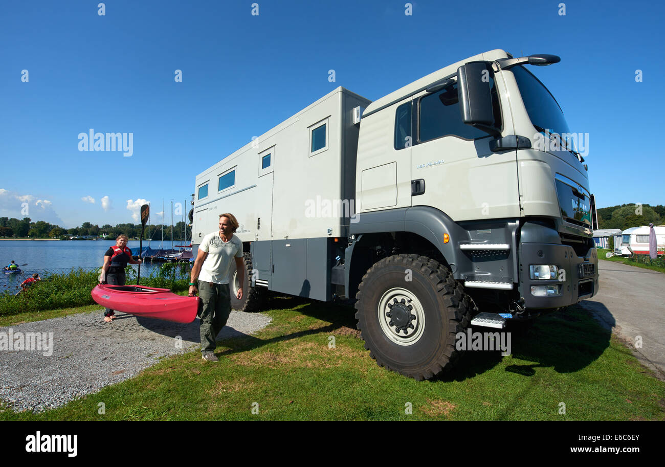 Models Michelle and Stefan carry a Lettmann canoe in front of a 'Global ...