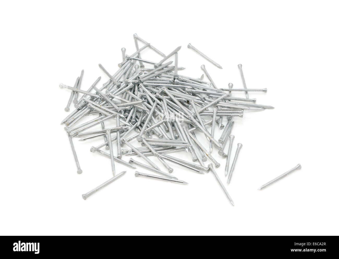 Pile of stainless steel panel pins, isolated on a white background ...