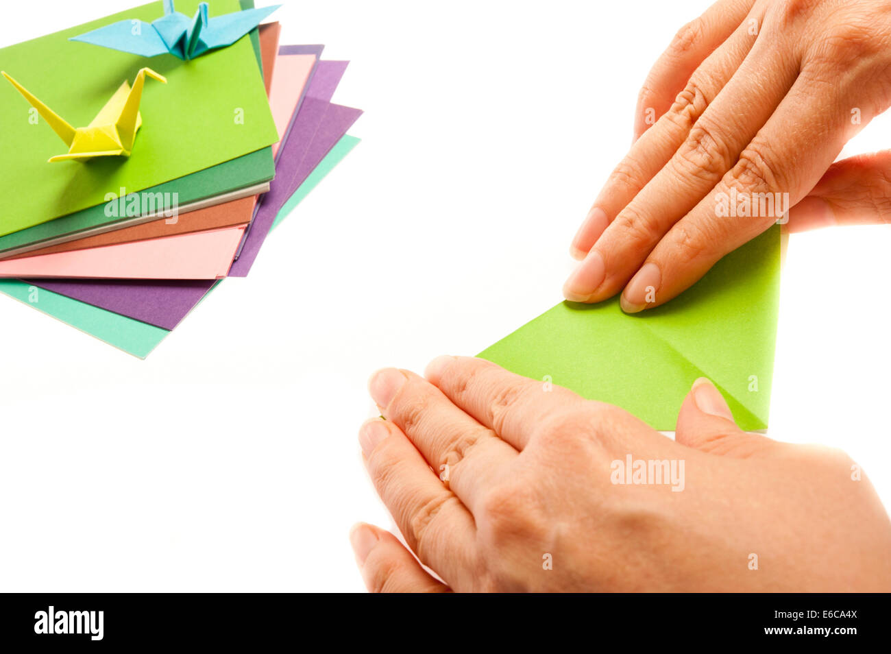 hands folding an origami bird Stock Photo - Alamy