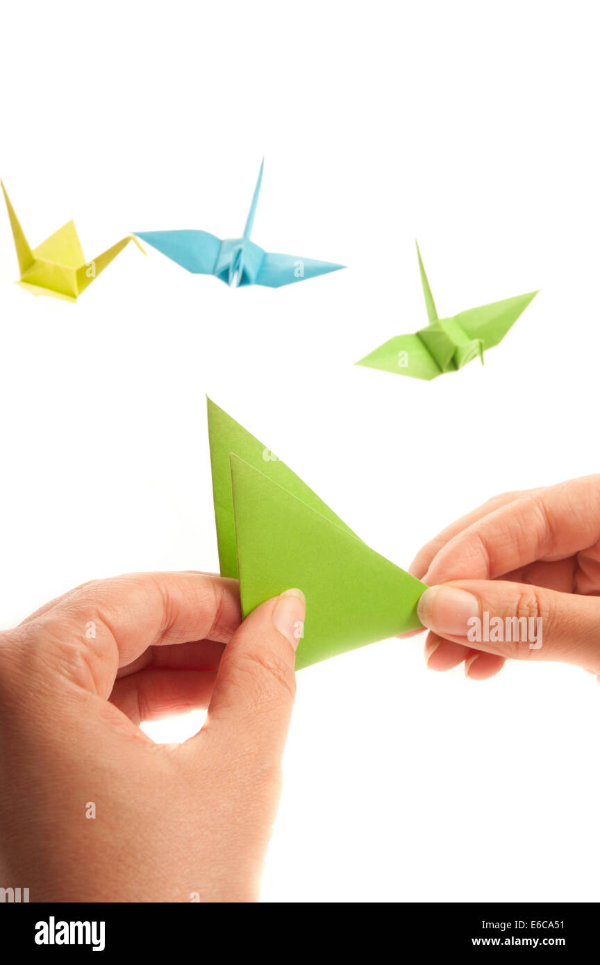 hands folding an origami bird Stock Photo - Alamy