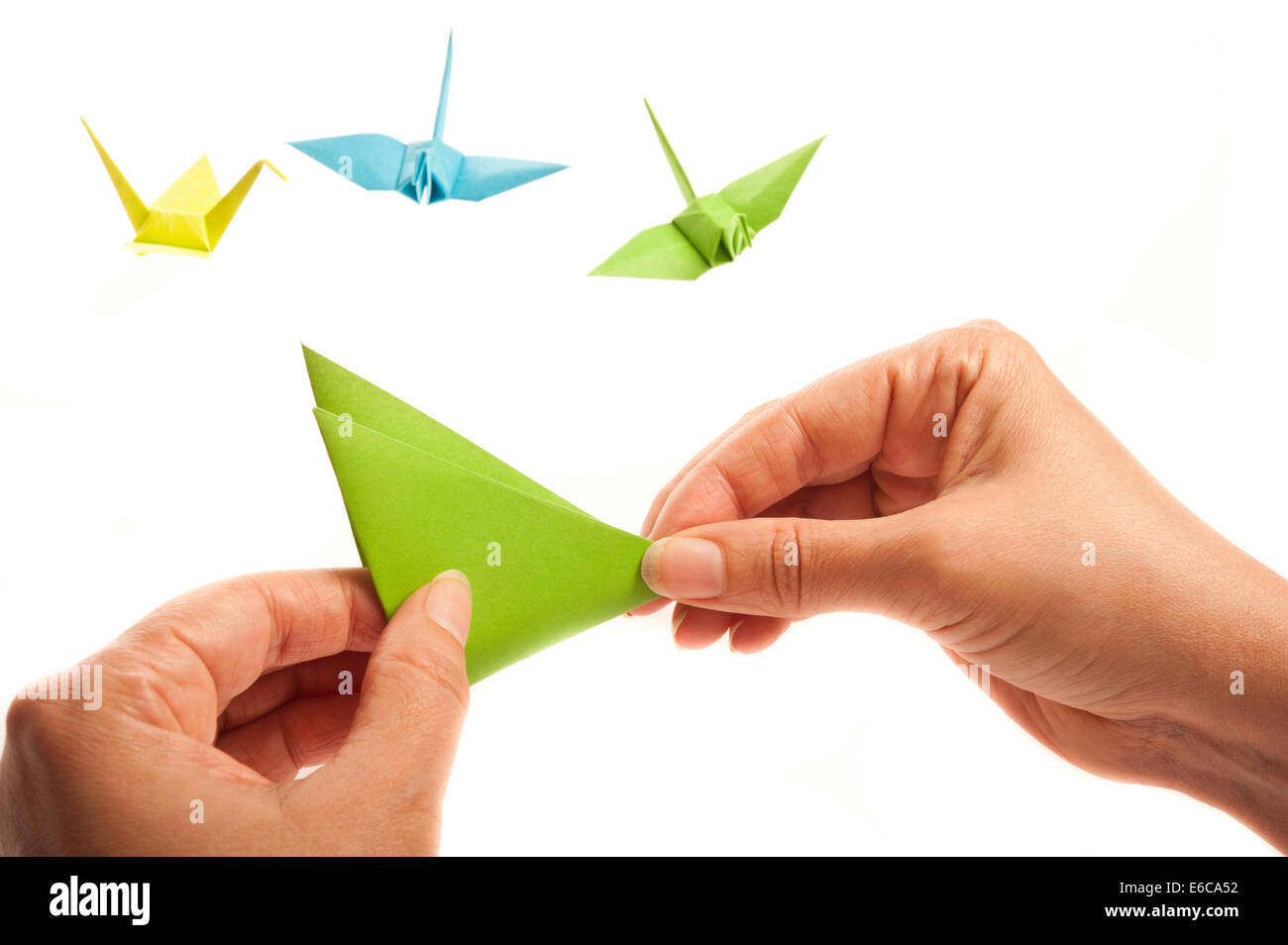 hands folding an origami bird Stock Photo - Alamy