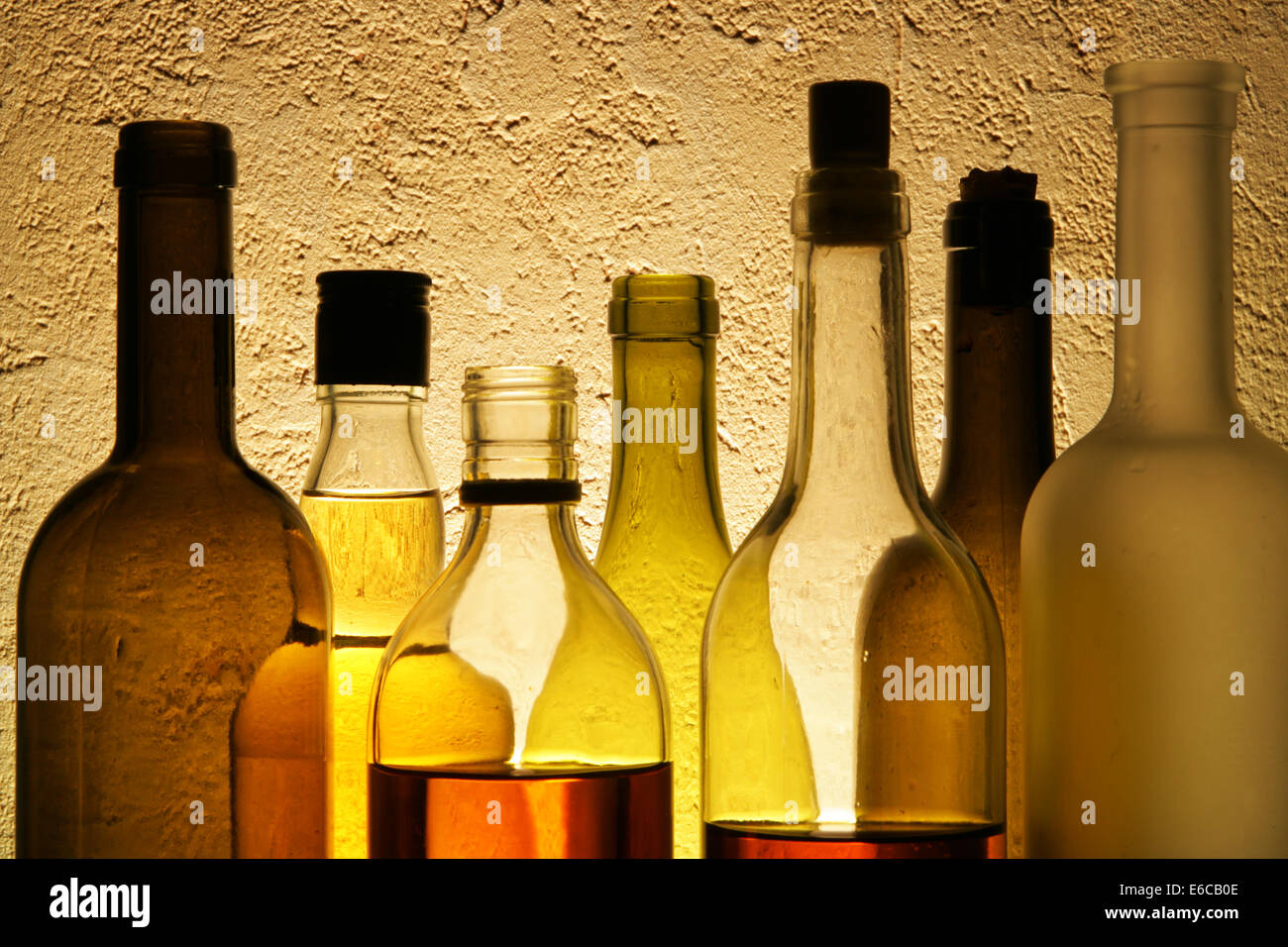 Still-life with bottles with alcohol over textyred background Stock ...