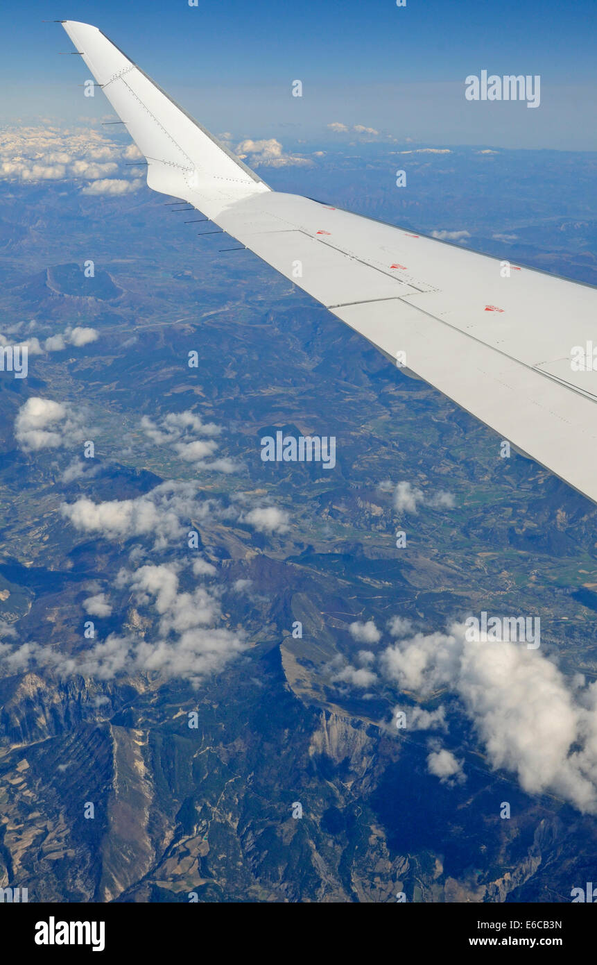 Wing of flying airplane over French Alps, France, Europe Stock Photo ...