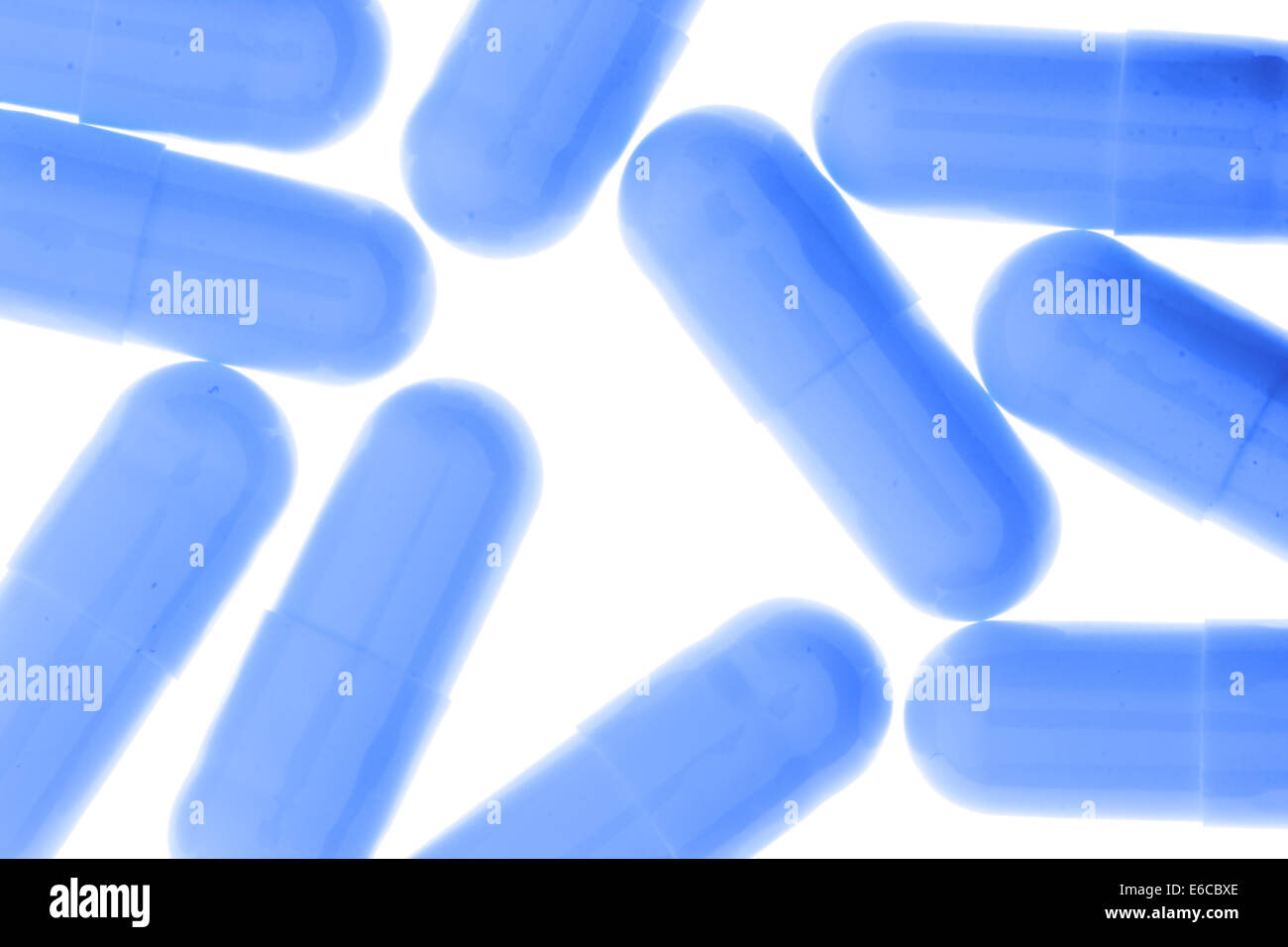 Blue capsules isolated over white background Stock Photo - Alamy