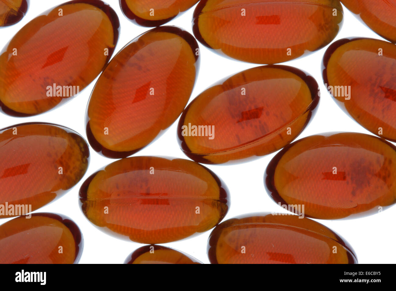 Red gelatinous capsules isolated over white background Stock Photo - Alamy