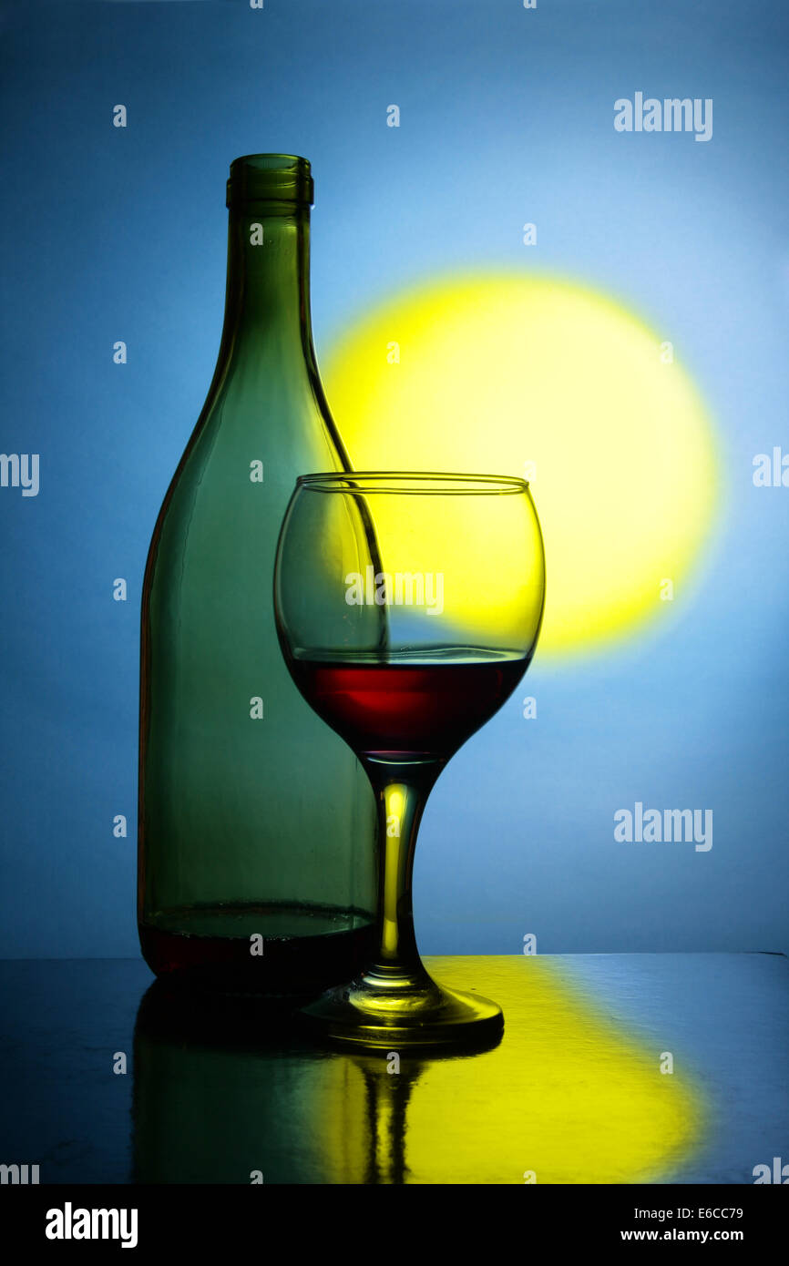Still life with bottle and glass of red wine Stock Photo - Alamy