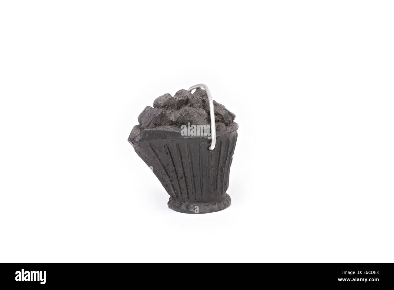 Lump of coal carved into miniature coal bucket isolated on white ...