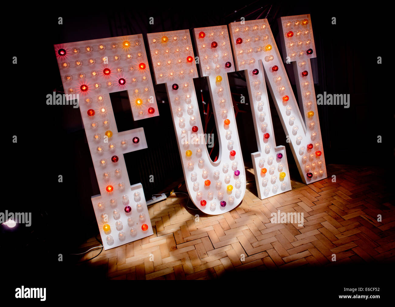 A large illuminated fairground sign of the word fun in East Sussex UK ...