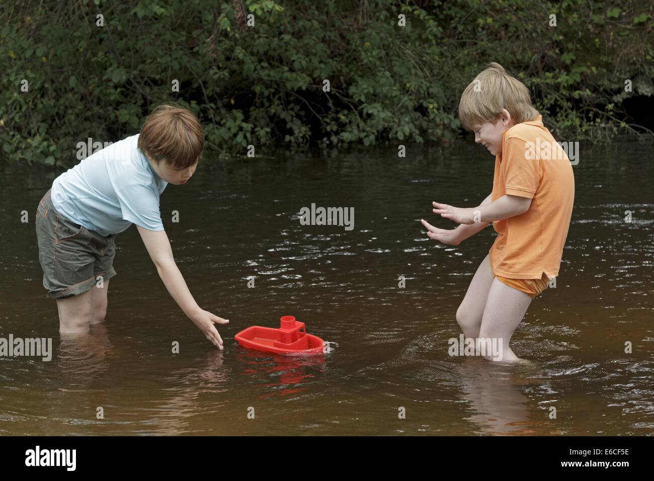 two children playing in a river Stock Photo - Alamy