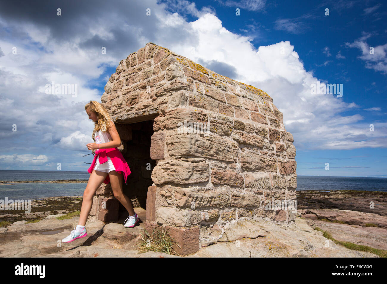 An old stone shelter on the shoreline in Seahouses, Northumberland, UK ...