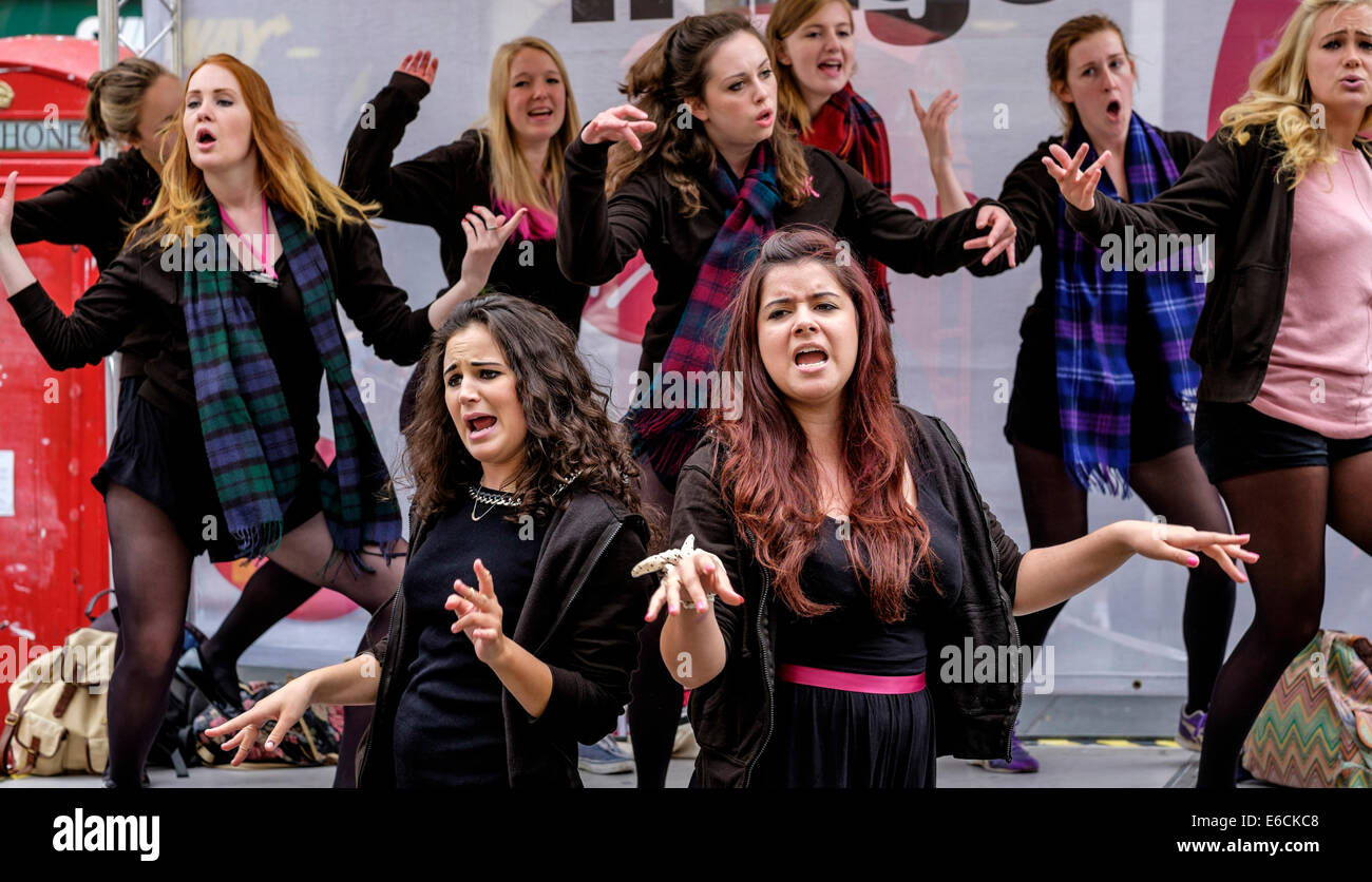 Fringe performers entertain and promote their show in the High Street ...
