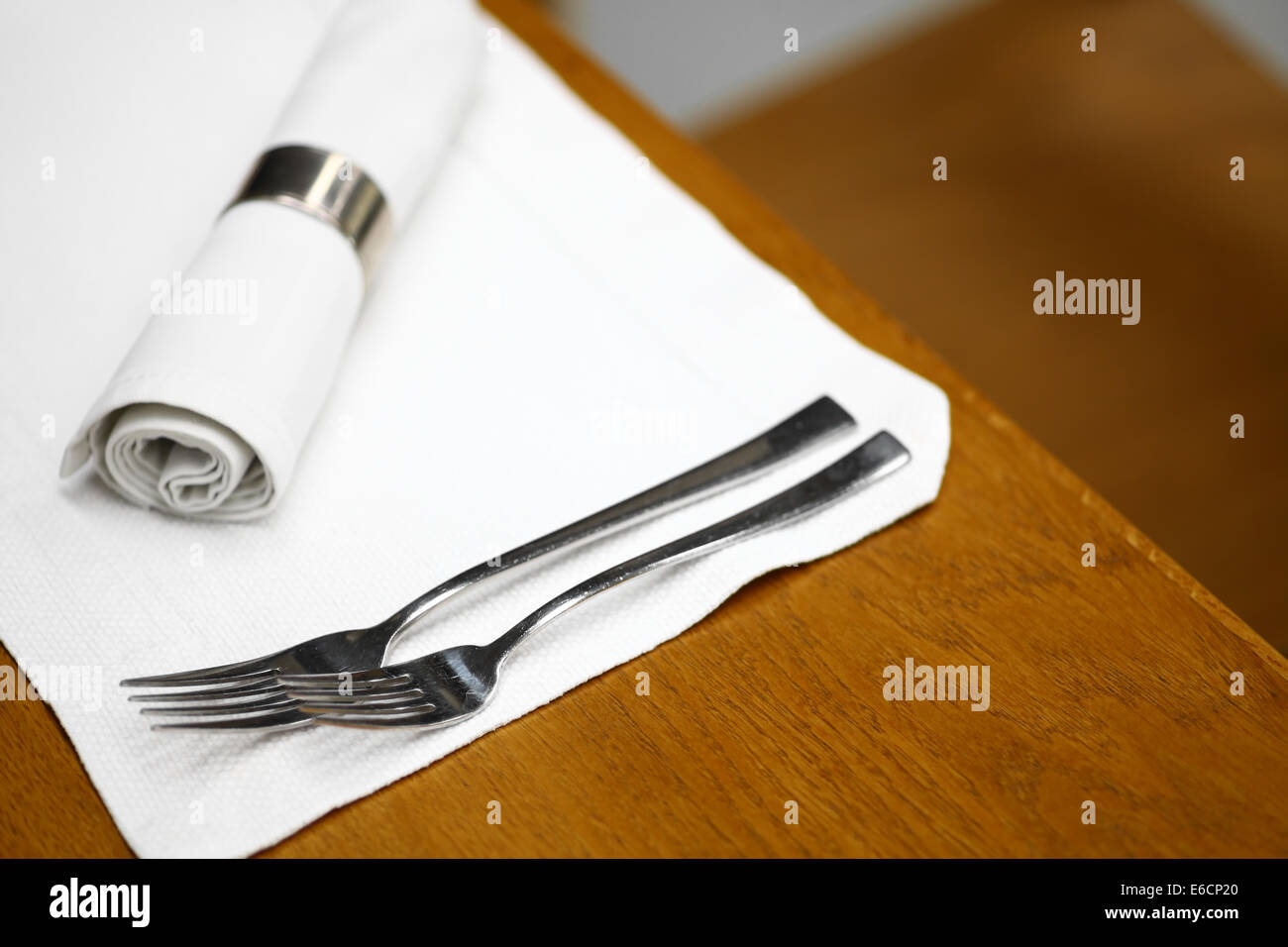 Two forks on a dinner table in a restaurant Stock Photo - Alamy