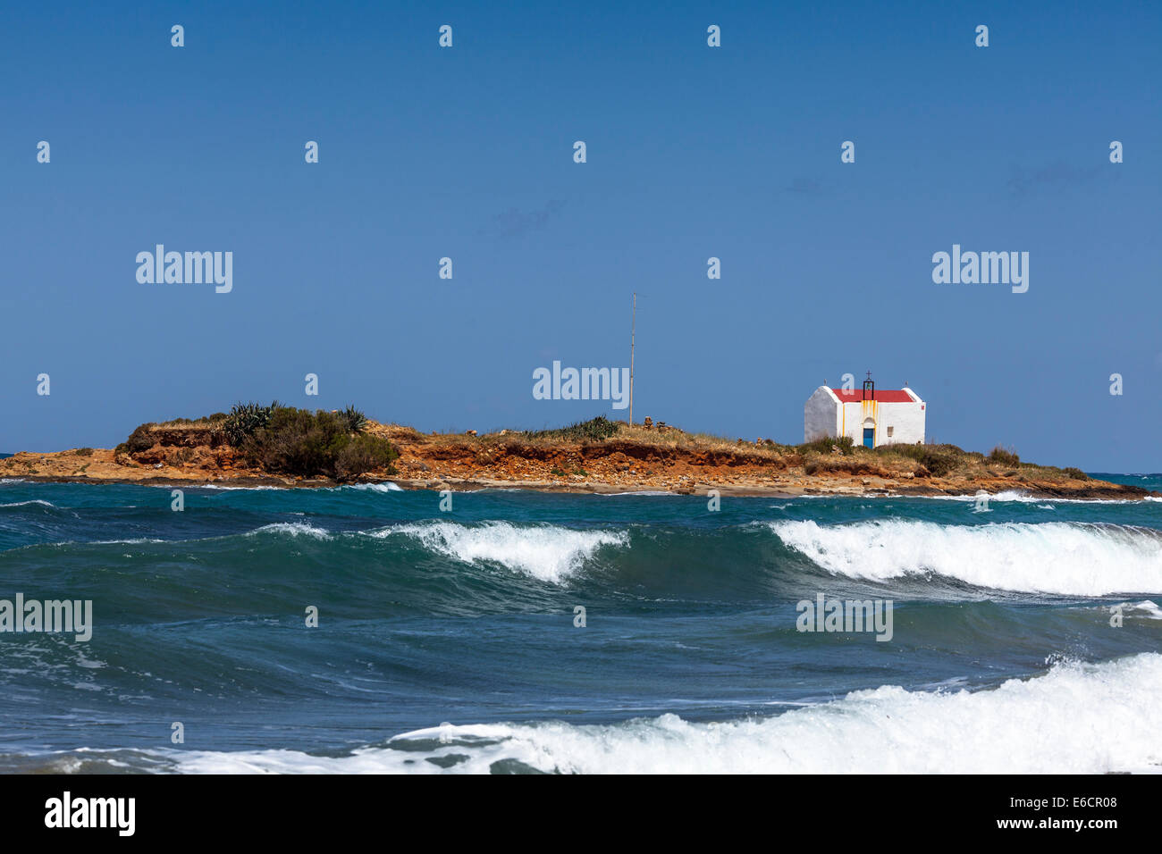 Picturesque church on island across Malia beach, Crete Stock Photo - Alamy