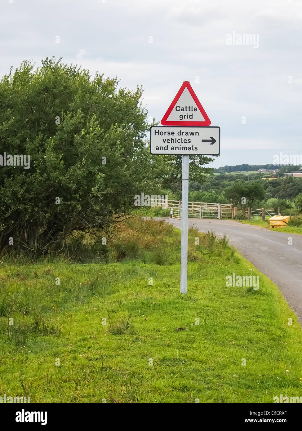 A road sign warning of a cattle grid ahead and giving directions for an ...