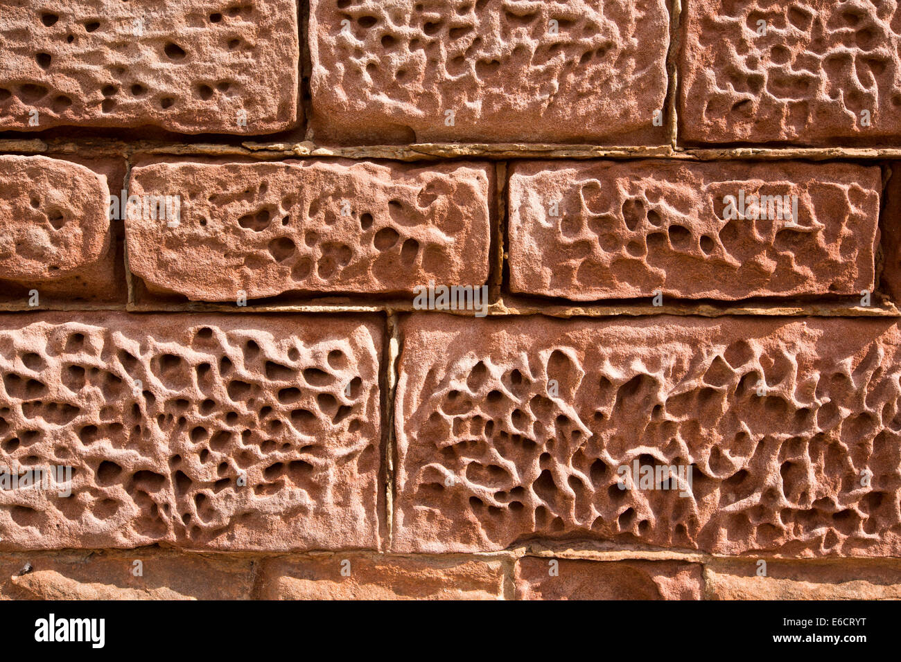 Weathered sandstone in the walls of Bamburgh Castle in Northumberland ...
