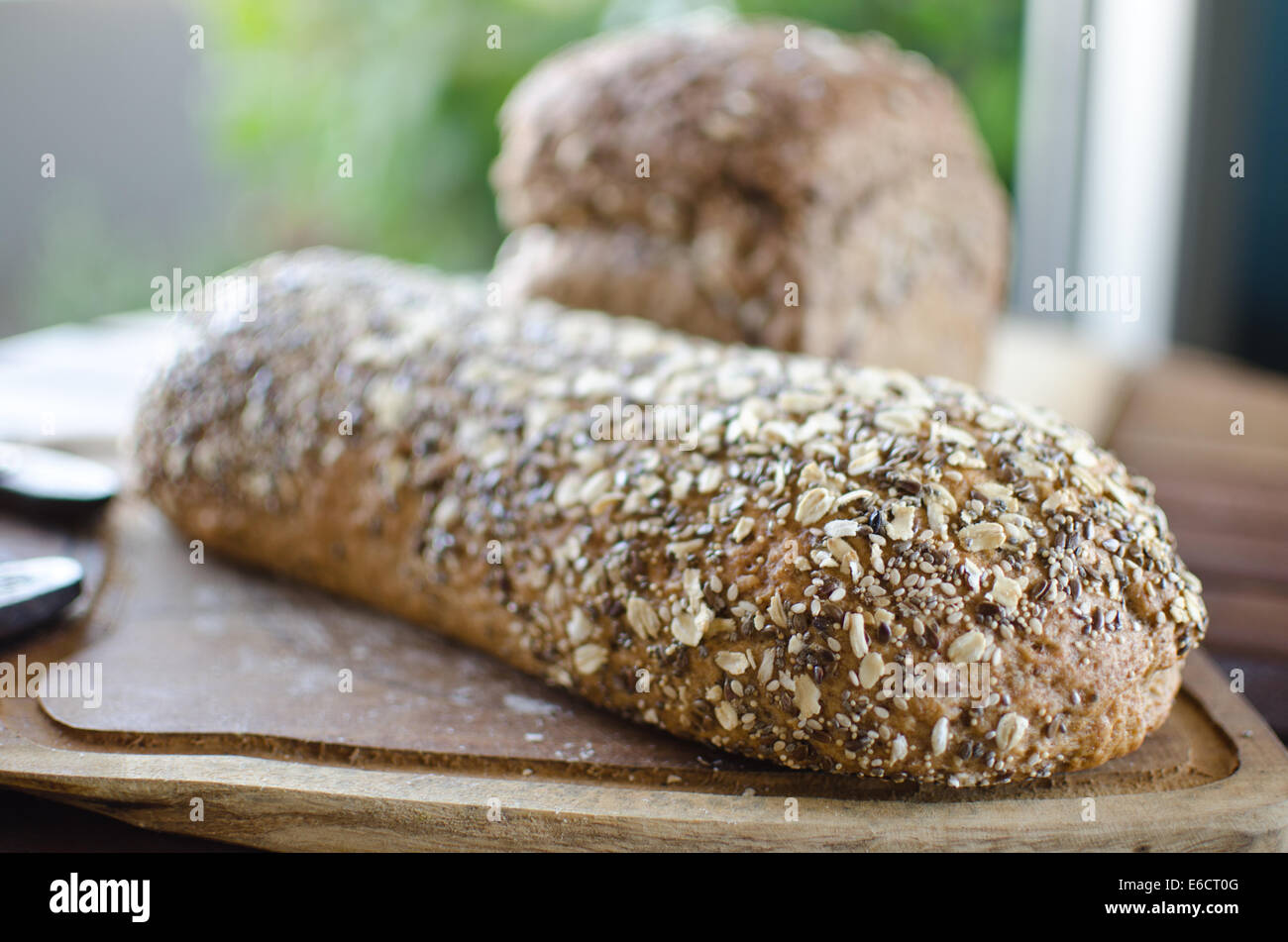 Pieces of homemade wholemeal bread over wooden table Stock Photo - Alamy