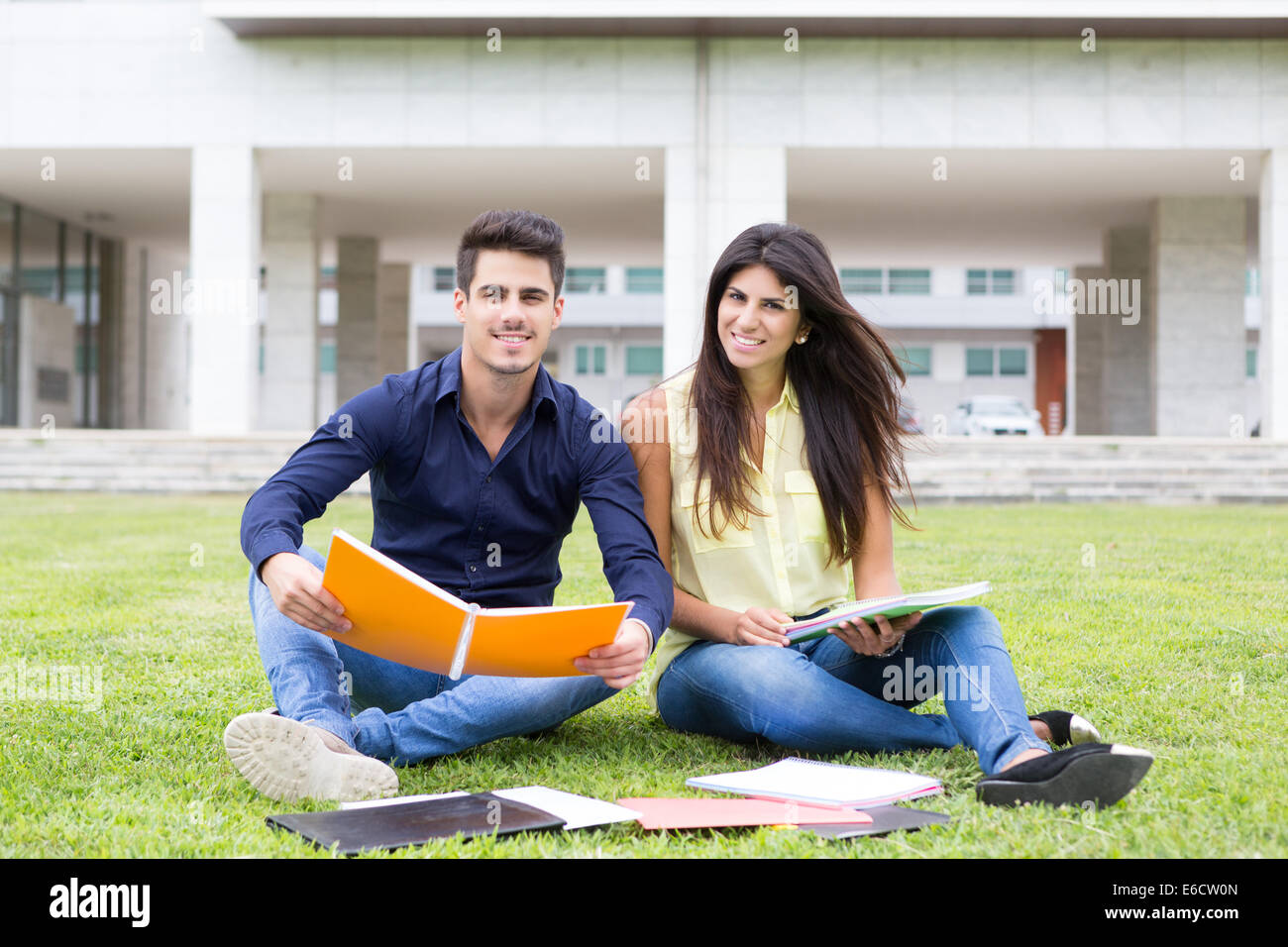 Couple of happy students at the university campus Stock Photo - Alamy