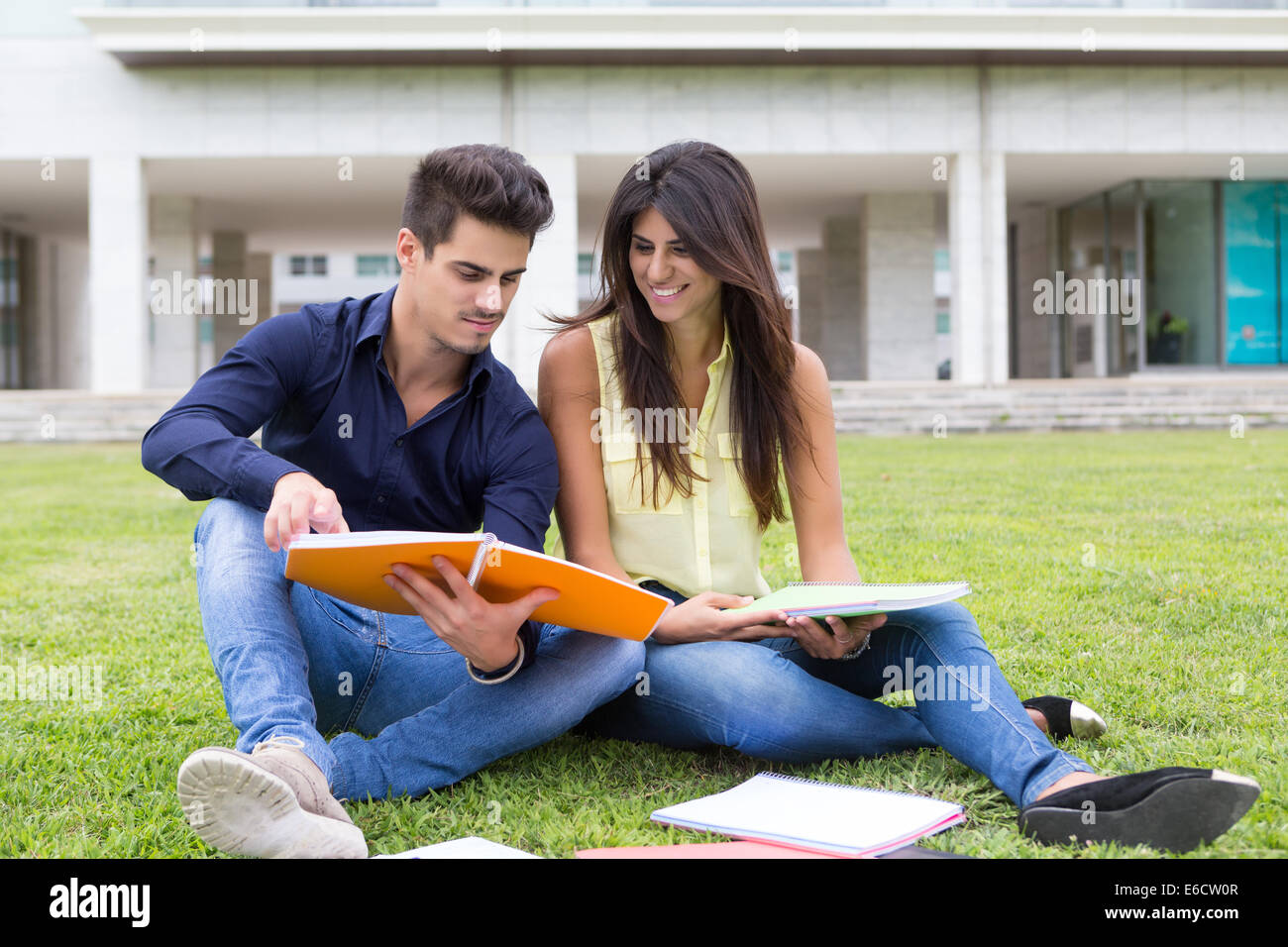 Couple of happy students at the university campus Stock Photo - Alamy