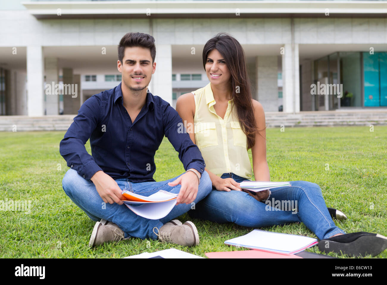 Couple of happy students at the university campus Stock Photo - Alamy