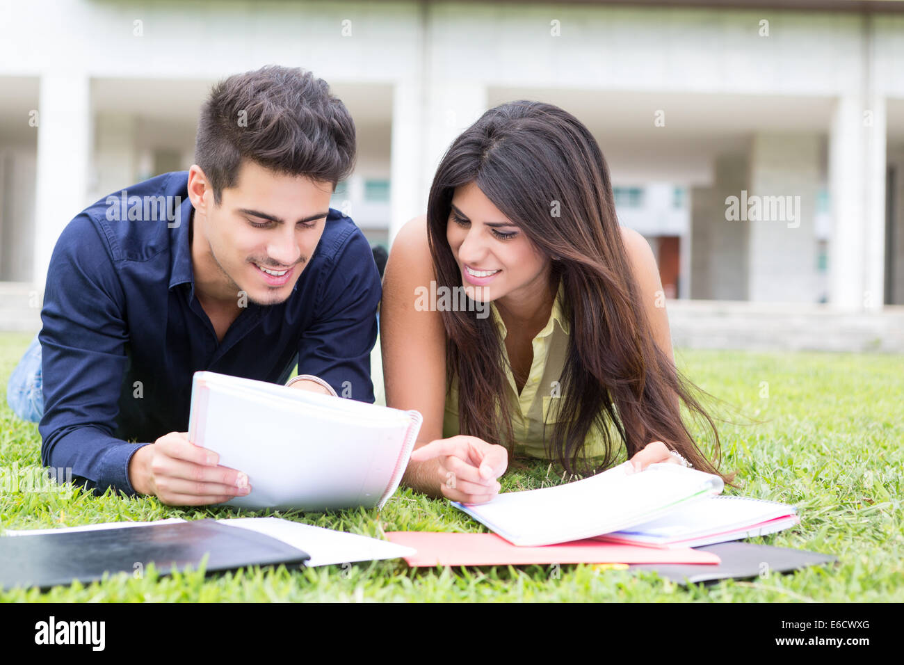 Couple of happy students at the university campus Stock Photo - Alamy