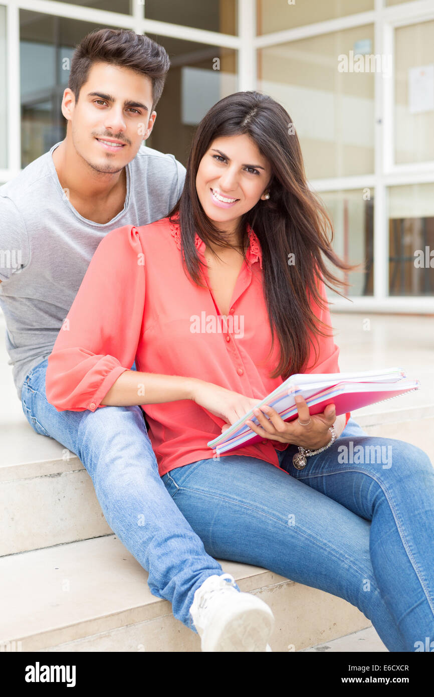 Couple of happy students at the university campus Stock Photo - Alamy